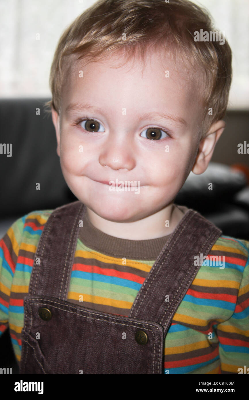 A young male toddler baby boy having fun playing, smiling, laughing and ...