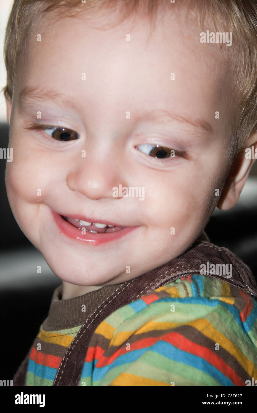 A young male toddler baby boy having fun playing, smiling, laughing and ...