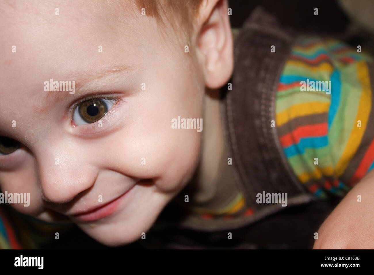 A young male toddler baby boy having fun playing, smiling, laughing and ...