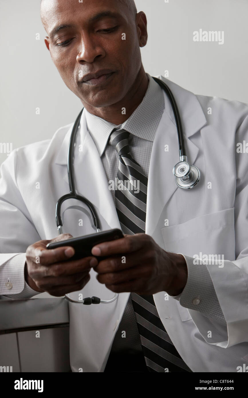 African american doctor text messaging hi-res stock photography and ...