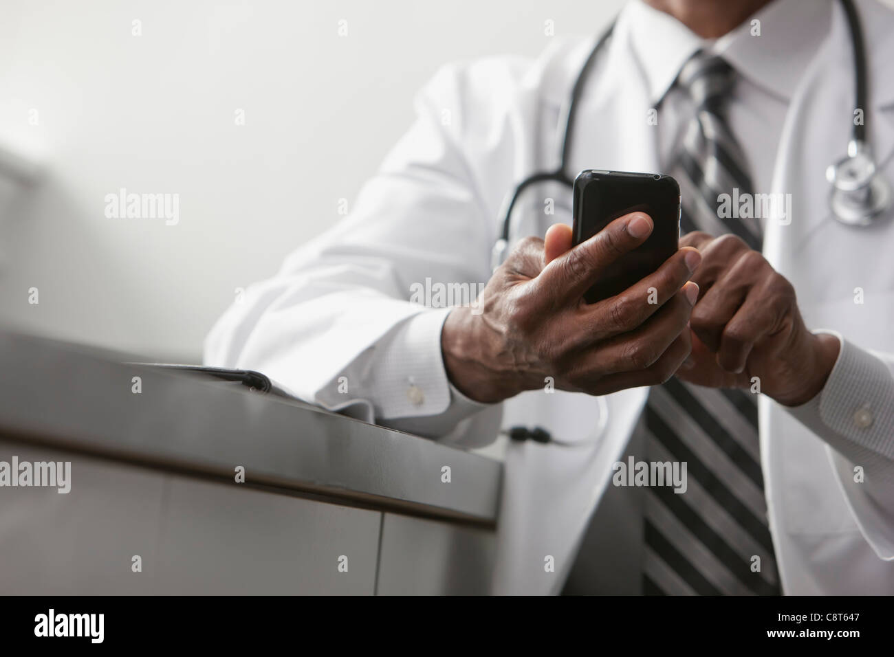 African american doctor text messaging hi-res stock photography and ...
