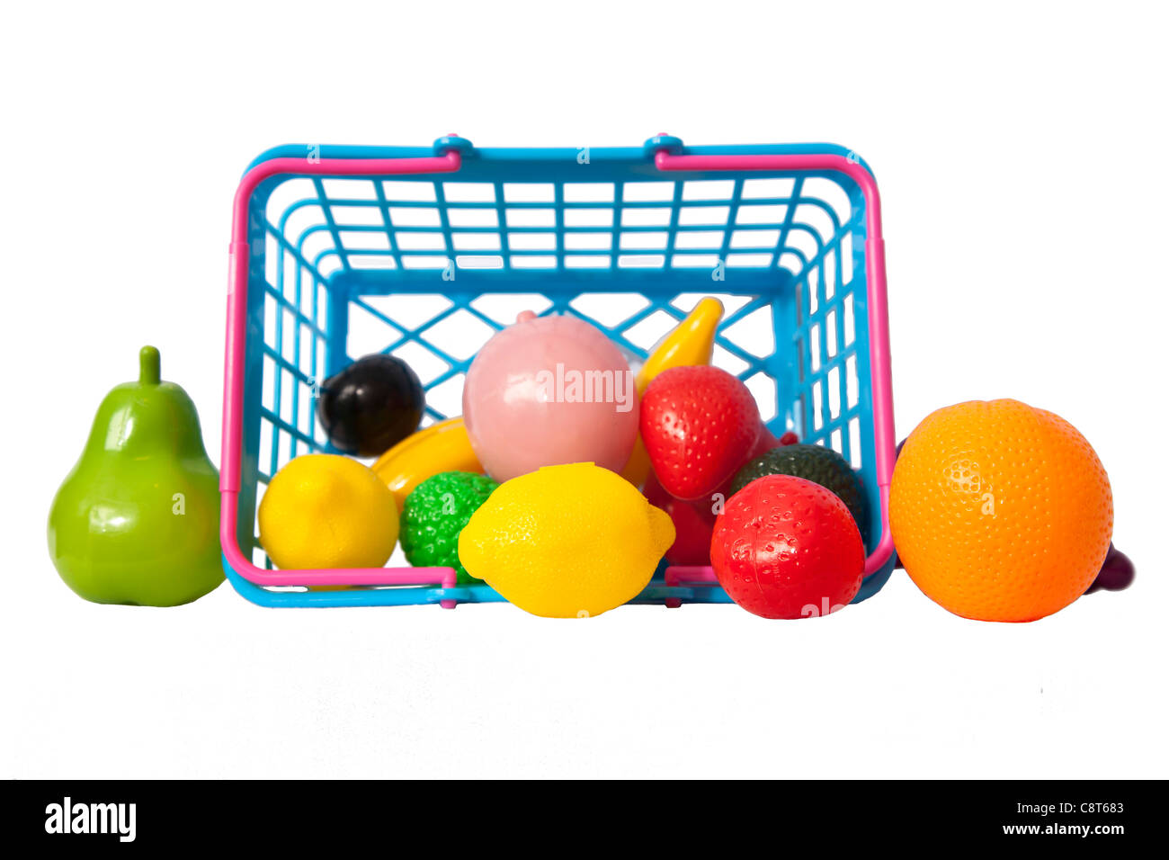 Plastic fruits with basket isolated on white Stock Photo - Alamy