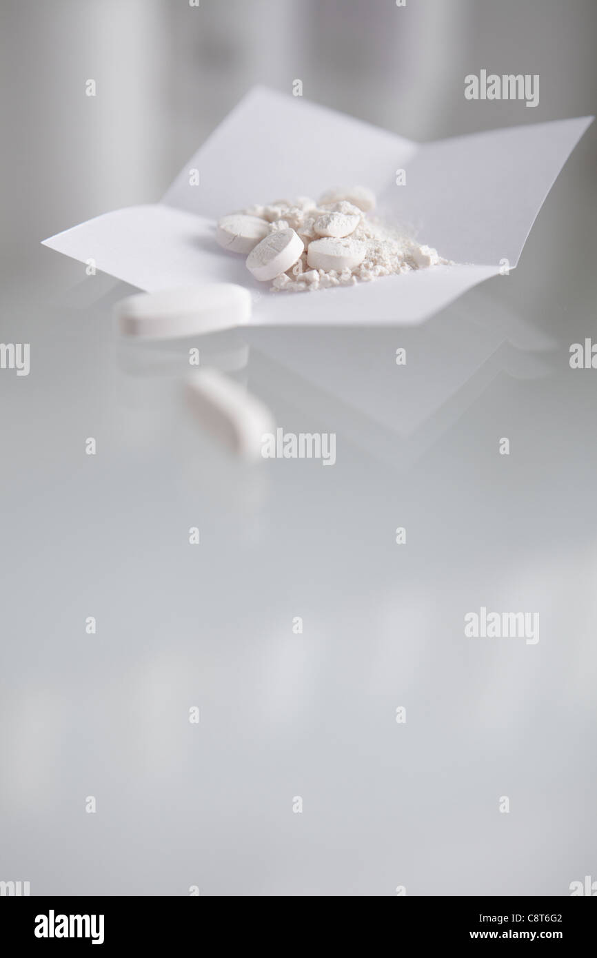 Crushed pills kept on piece of paper Stock Photo - Alamy