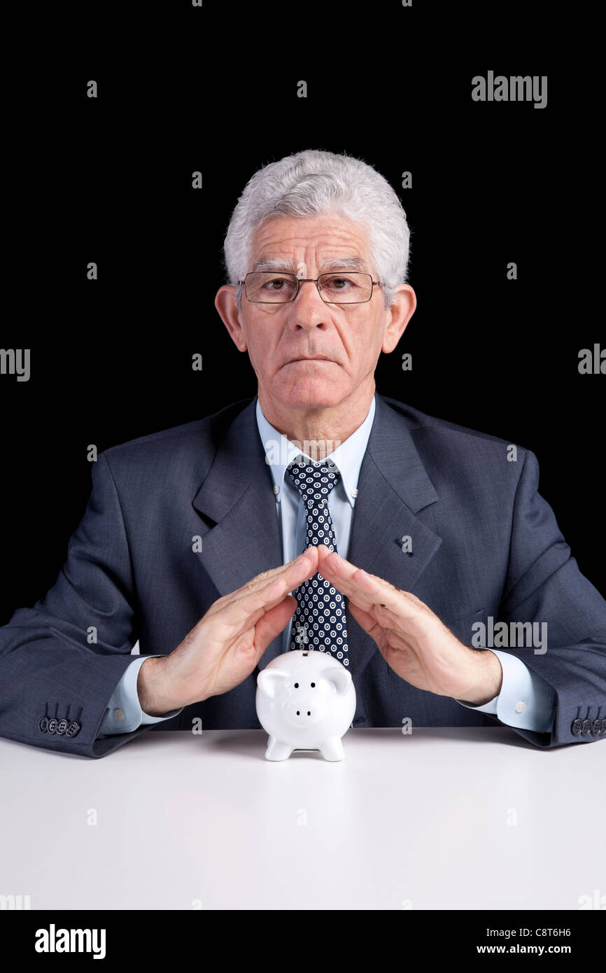 Senior businessman saving some money for his retirement (isolated on ...