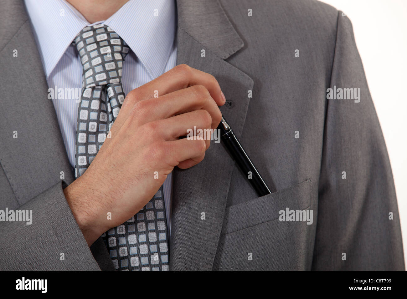 A cropped picture of a man putting a pen in his pocket Stock Photo - Alamy
