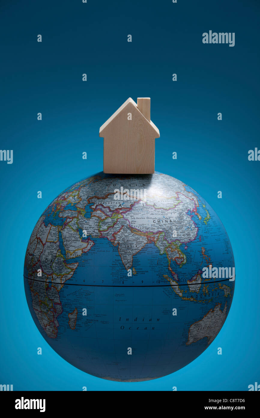 Globe And House With Blue Background Stock Photo - Alamy