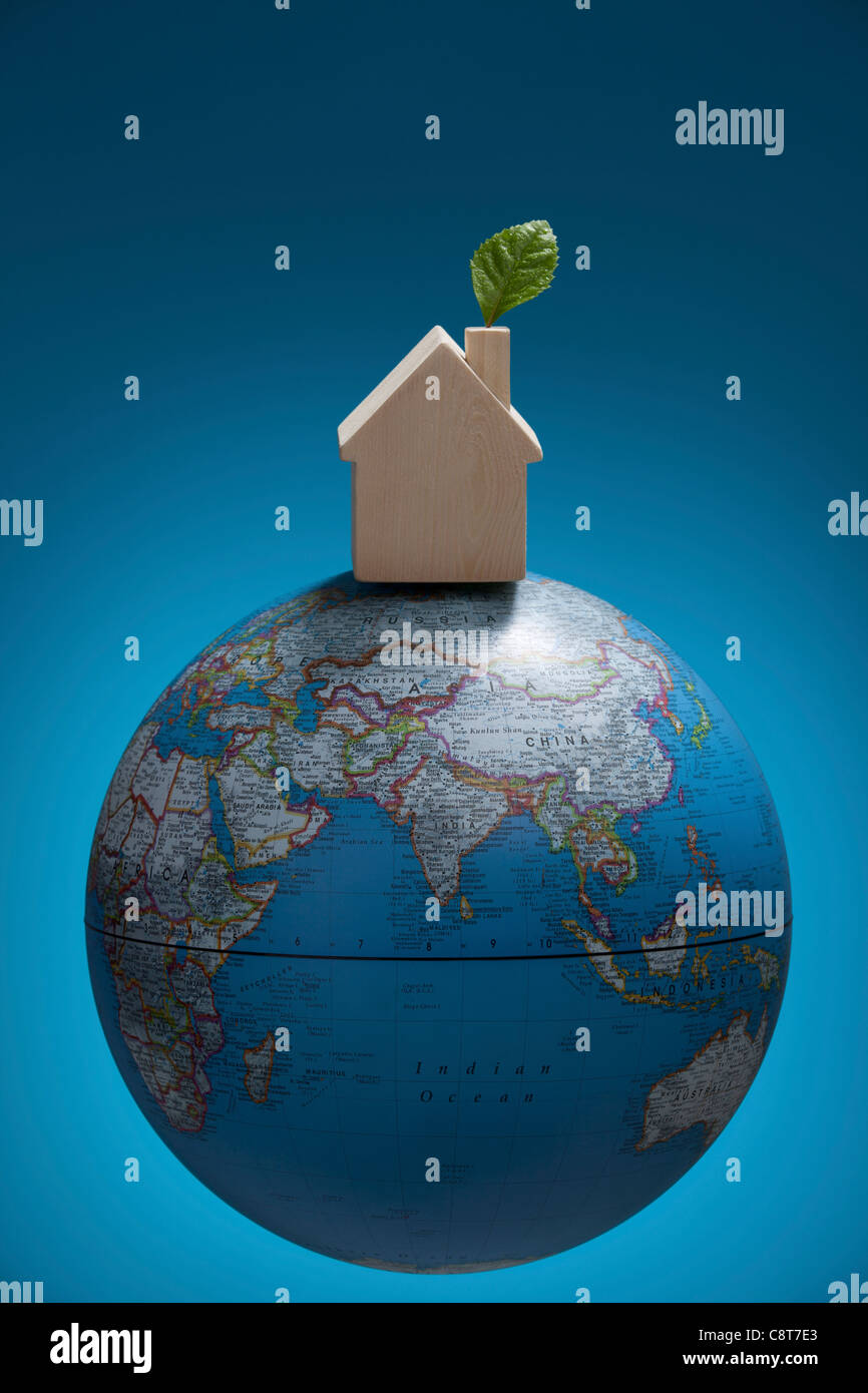 Globe And House With Blue Background Stock Photo - Alamy
