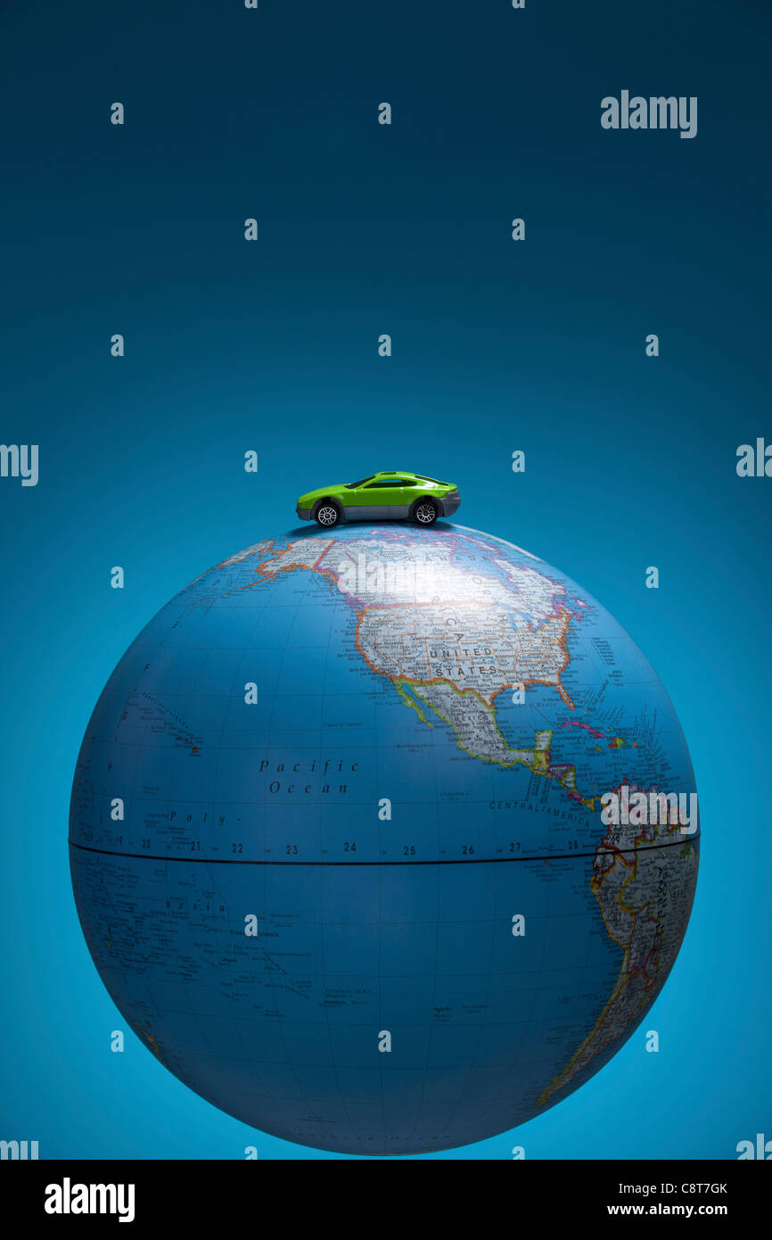 Globe And Toy Car With Blue Background Stock Photo - Alamy