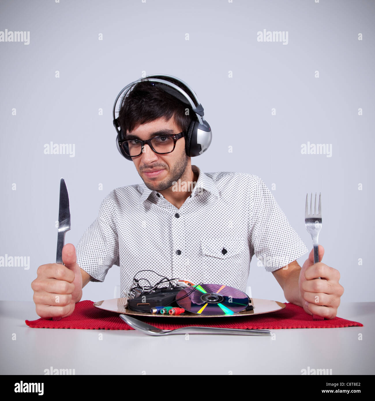 Crazy young man eating music at his dinner plate Stock Photo - Alamy