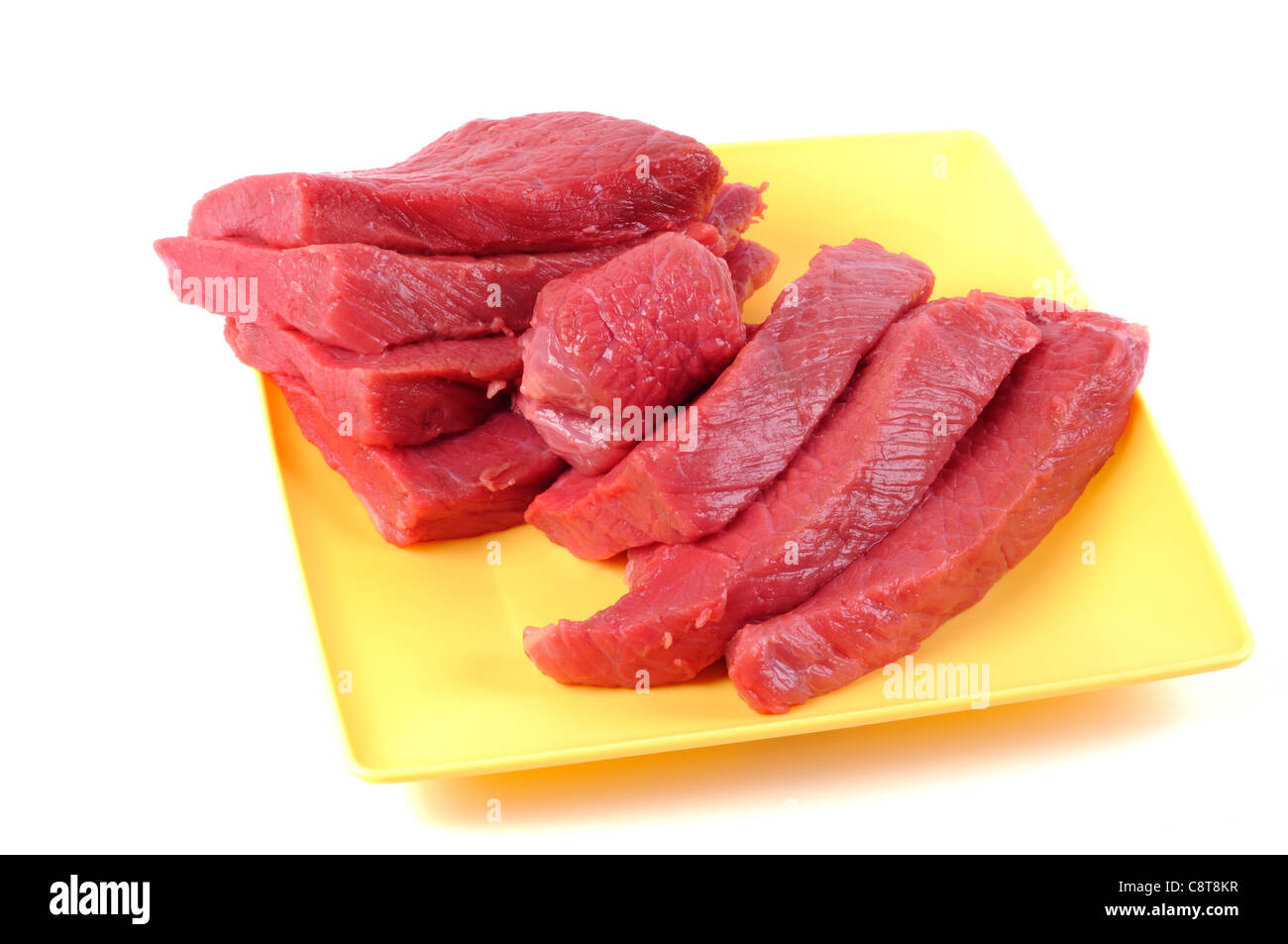 Fresh raw beef steak on a yellow plate, white background Stock Photo ...