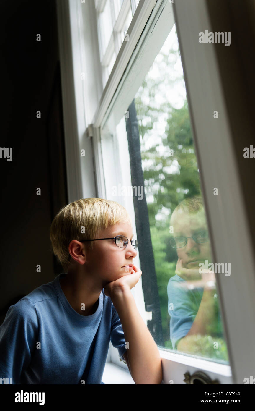 USA, New York, Old Westbury, Boy looking out window Stock Photo - Alamy