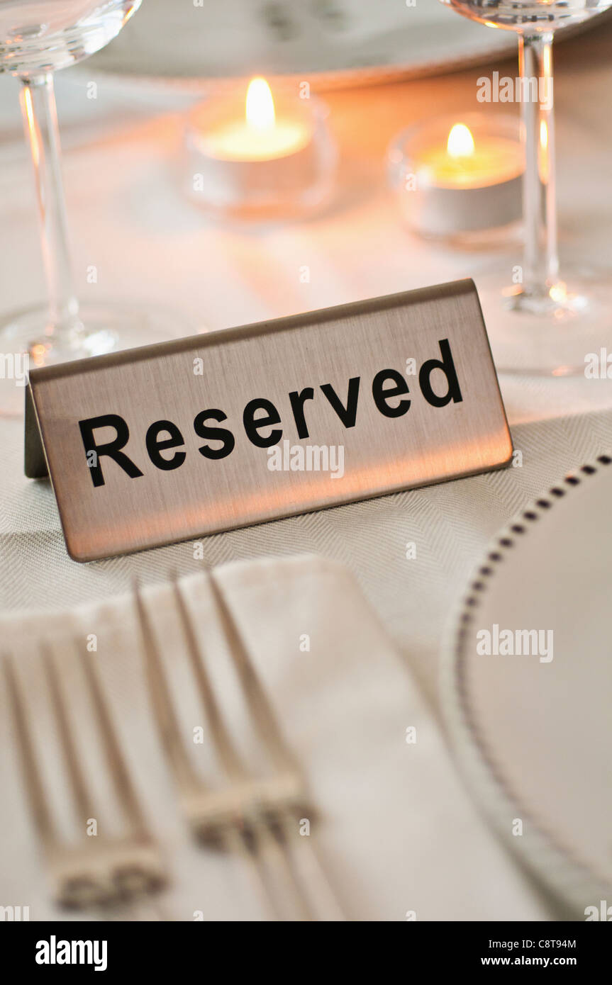Reservation tag on dining table Stock Photo - Alamy