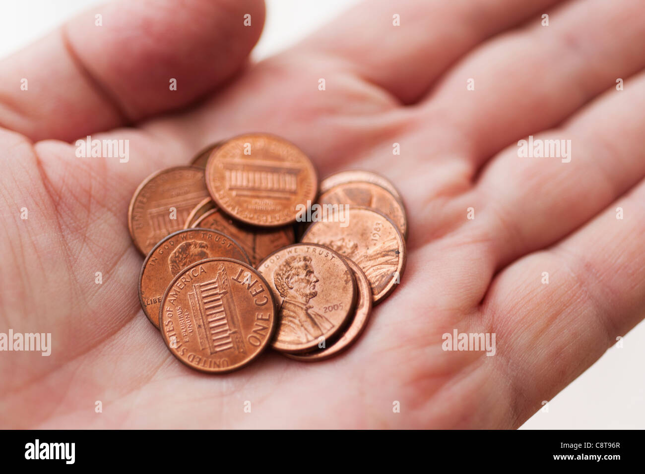 Male hand holding coins Stock Photo - Alamy