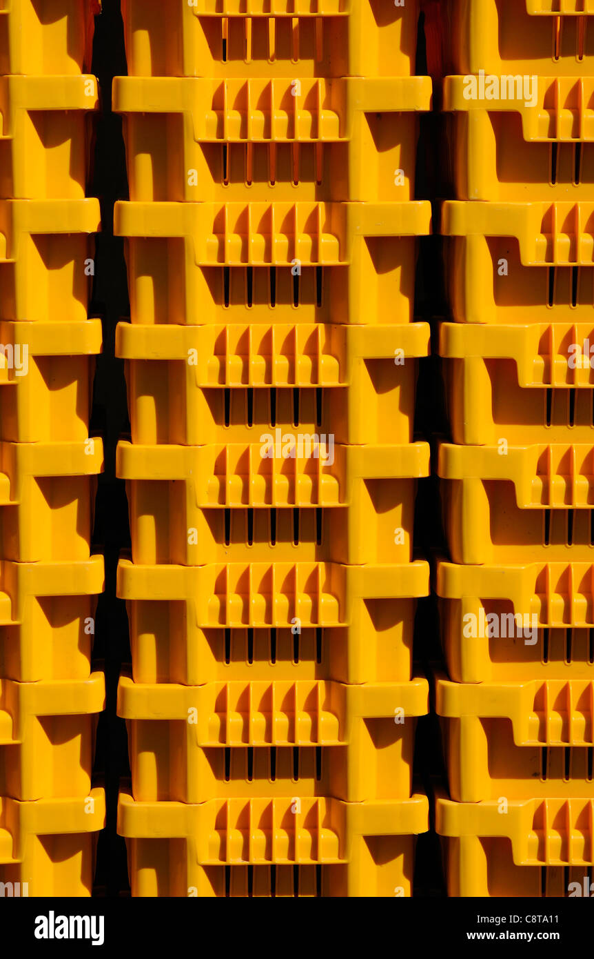 Stacked rack of orange plastic crates used for harvesting grapes in a ...