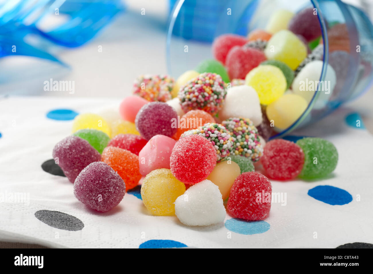Sugar coated jelly candies spilling from a cup Stock Photo - Alamy