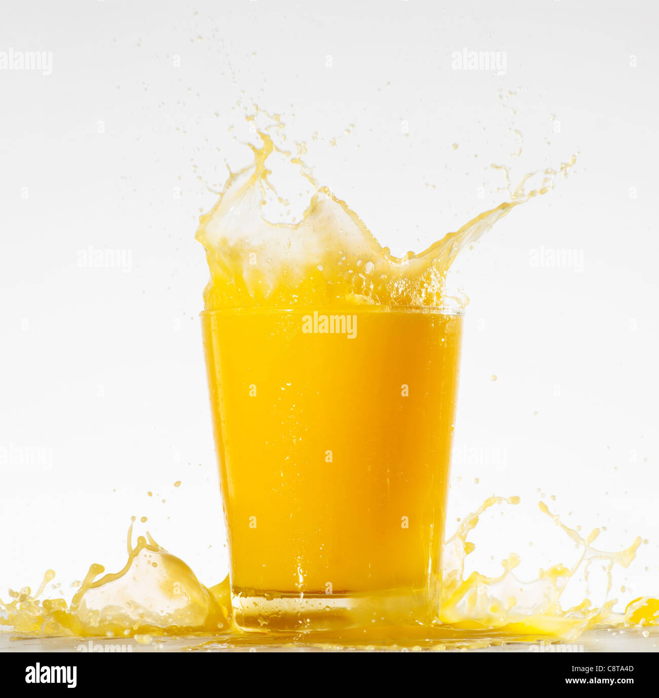 Studio shot of orange juice with splash Stock Photo - Alamy