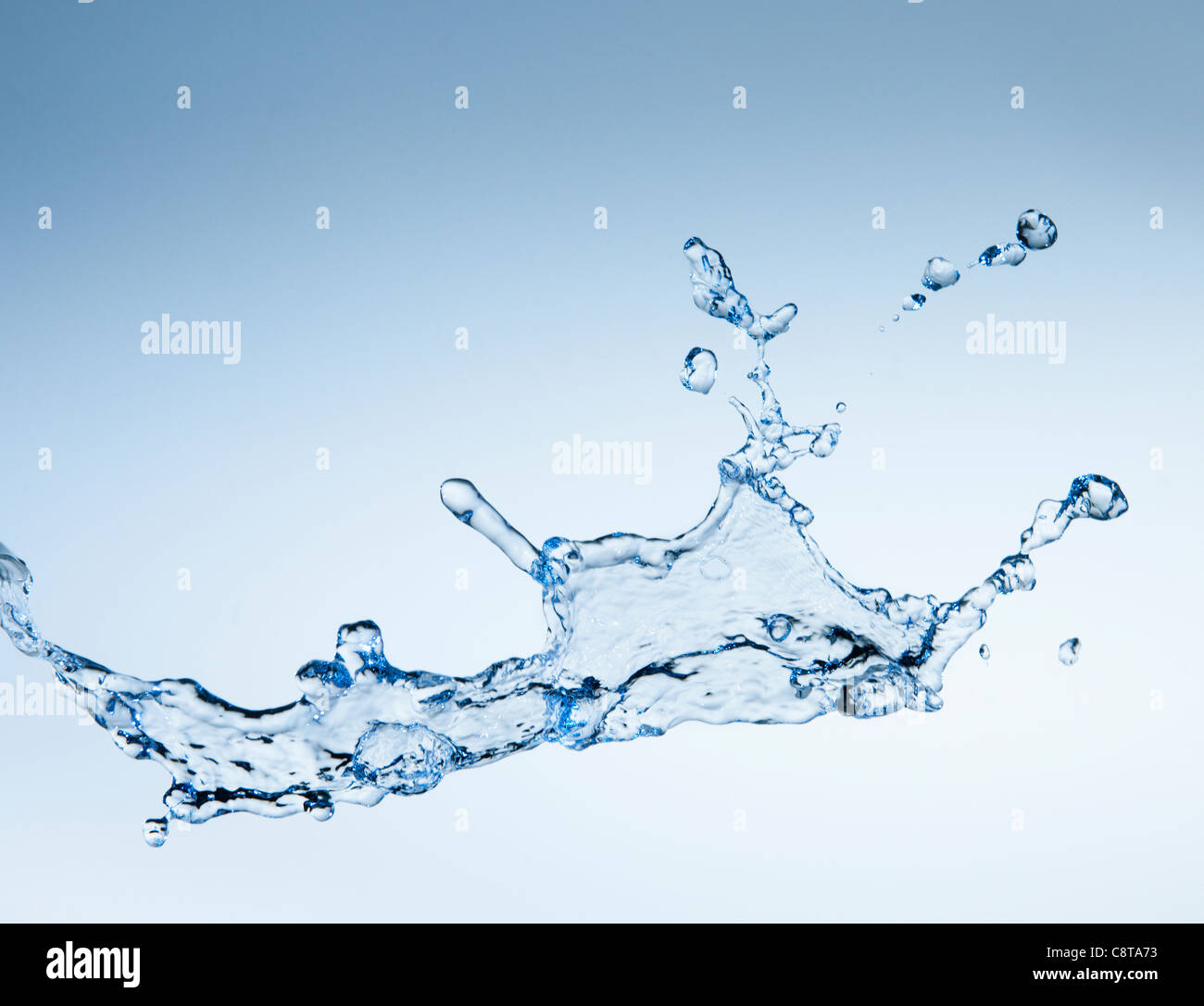 Studio shot of water splash on blue background Stock Photo - Alamy