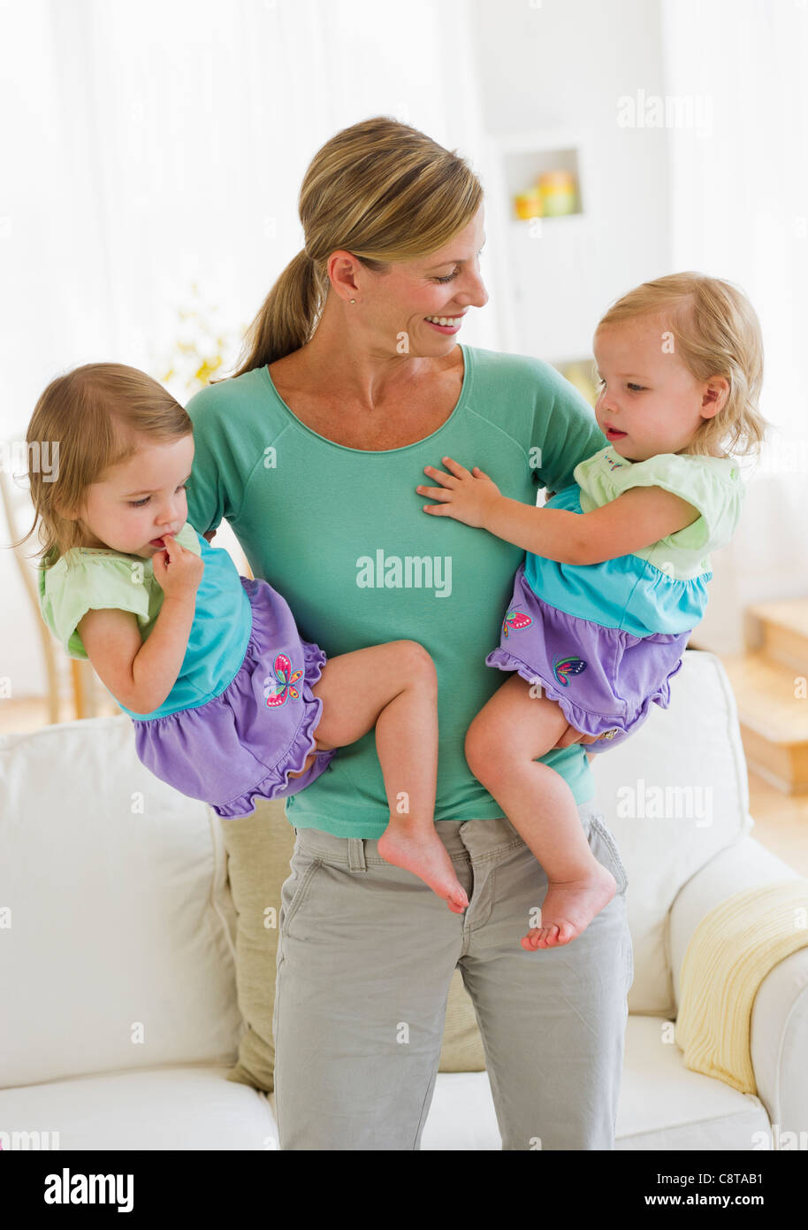 Mother with daughters in living room Stock Photo - Alamy