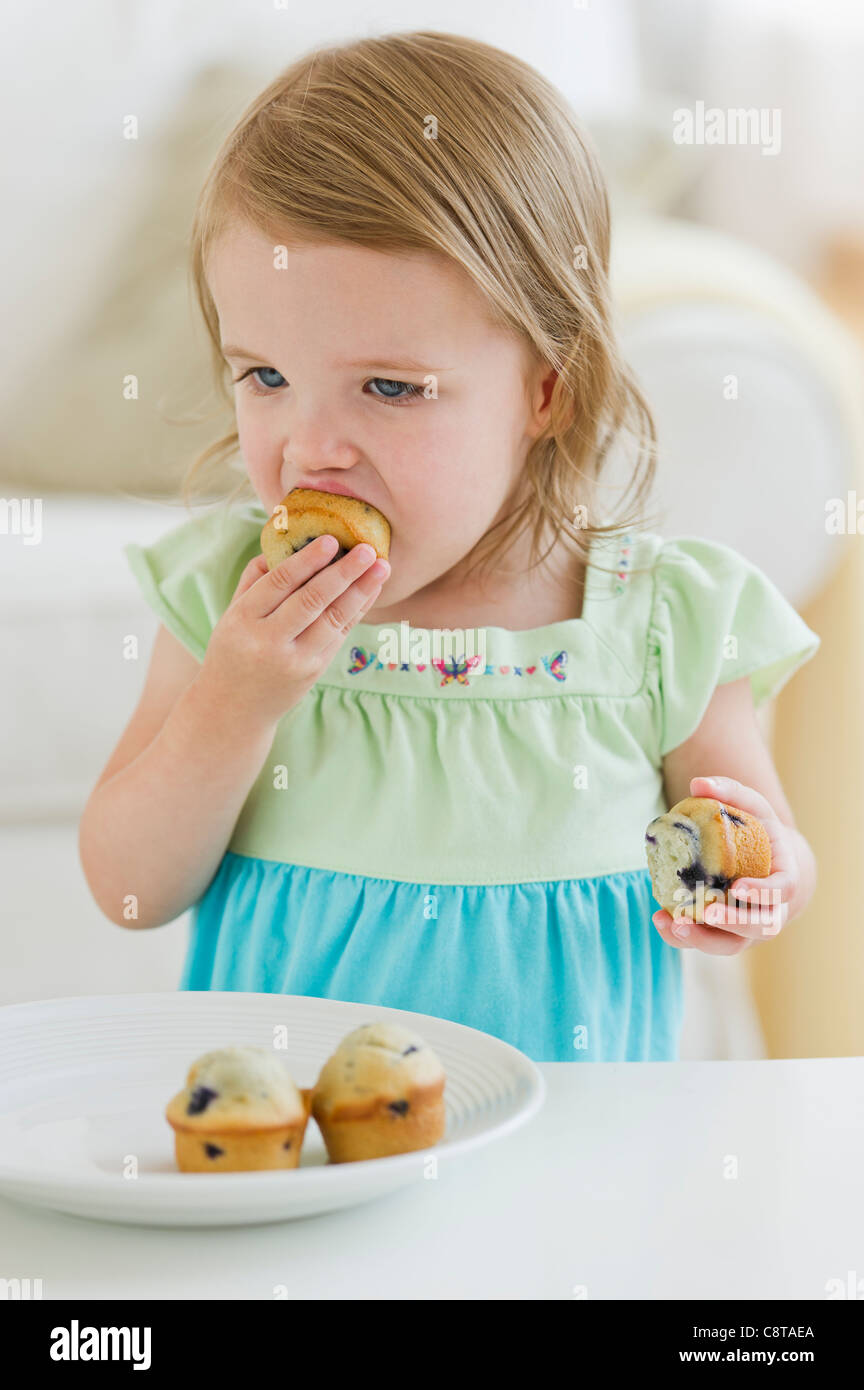 Girl eating muffins Stock Photo - Alamy