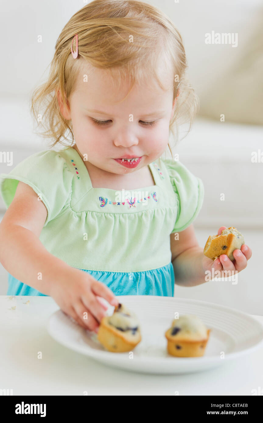 Girl eating muffins Stock Photo - Alamy
