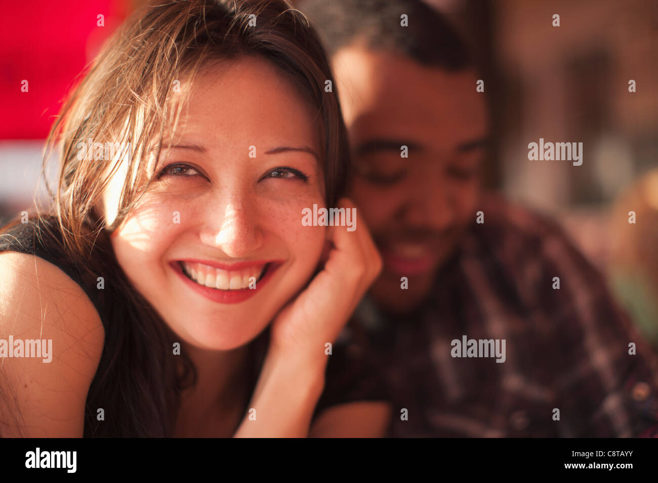 Smiling couple sitting together Stock Photo - Alamy