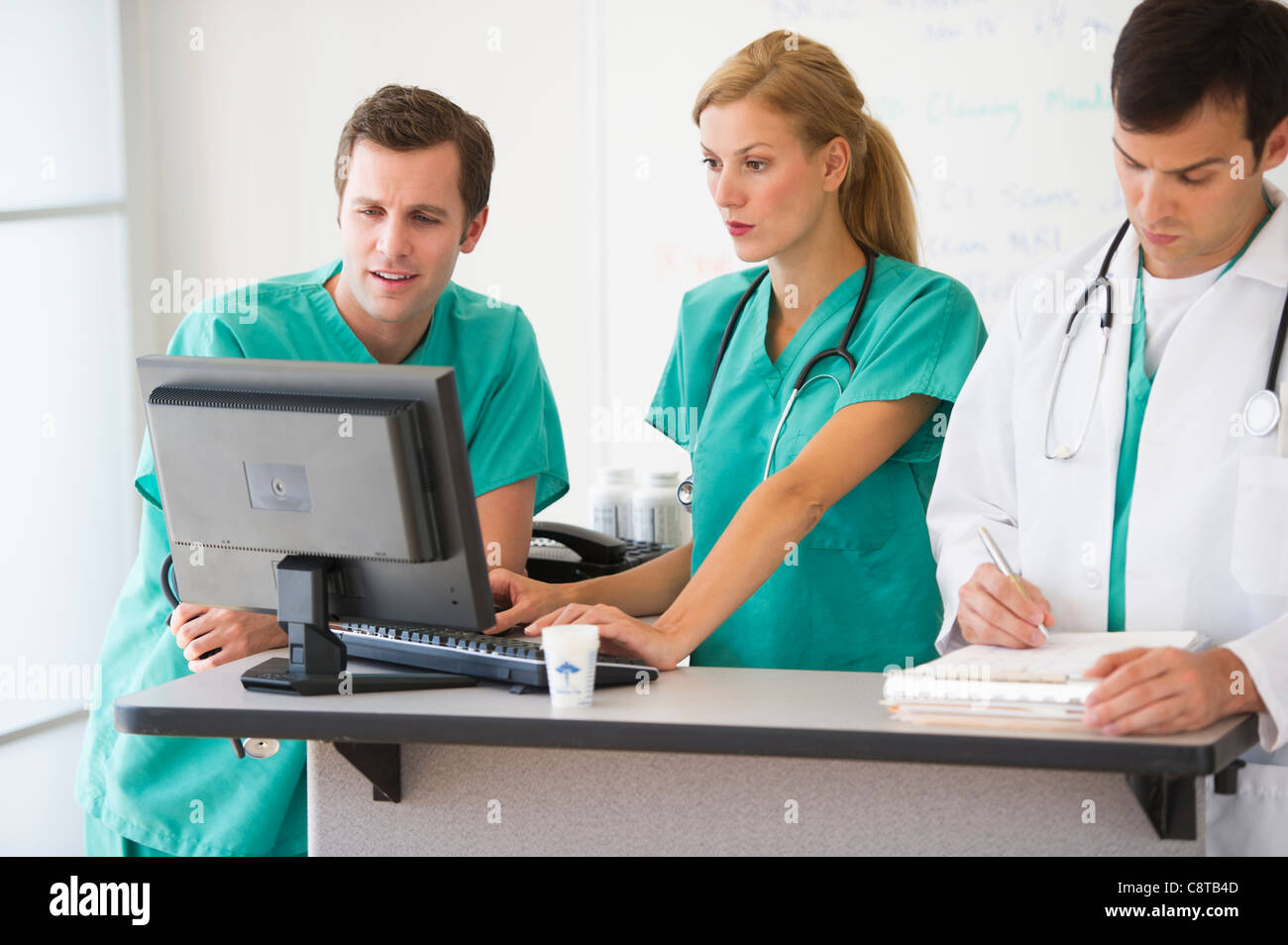 Group nurses looking at computer hi-res stock photography and images ...