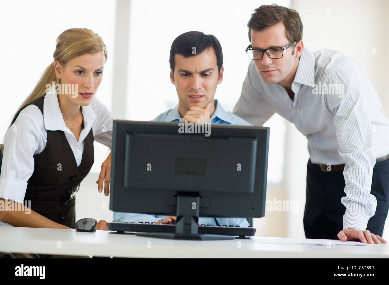 USA, New Jersey, Jersey City, Business team looking at computer Stock ...