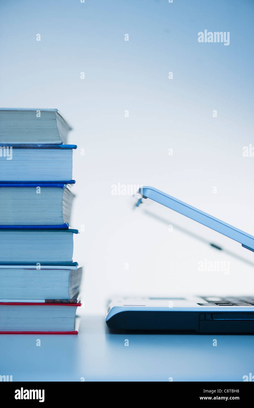Studio shot of books and laptop Stock Photo - Alamy