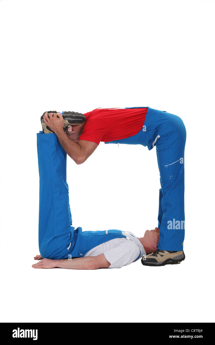 Two builders making square shape Stock Photo - Alamy