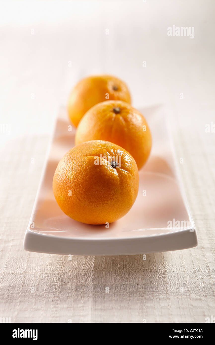 Three Oranges And Tray Stock Photo - Alamy