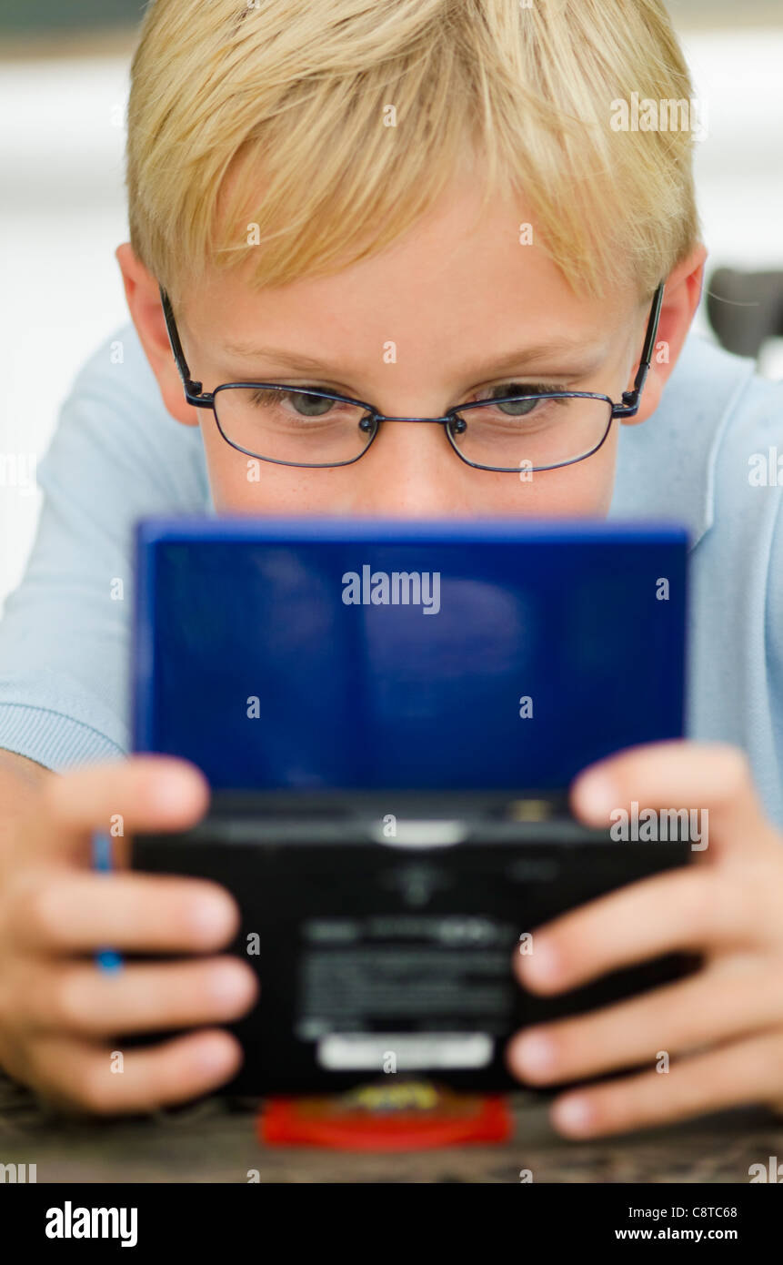 Boy playing handheld video hi-res stock photography and images - Alamy