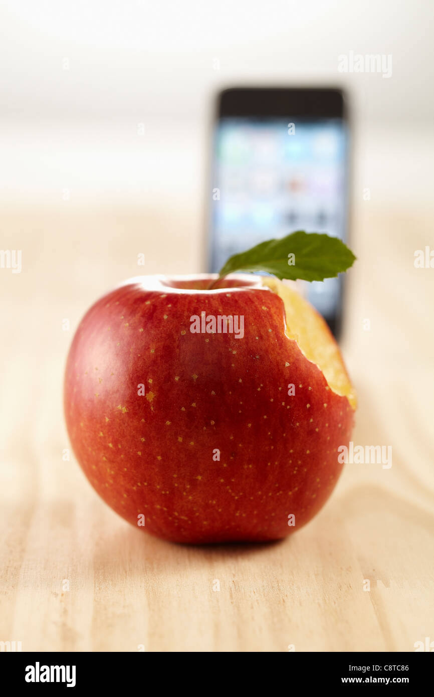 Close-up Of Apple With Mobile Phone Stock Photo - Alamy