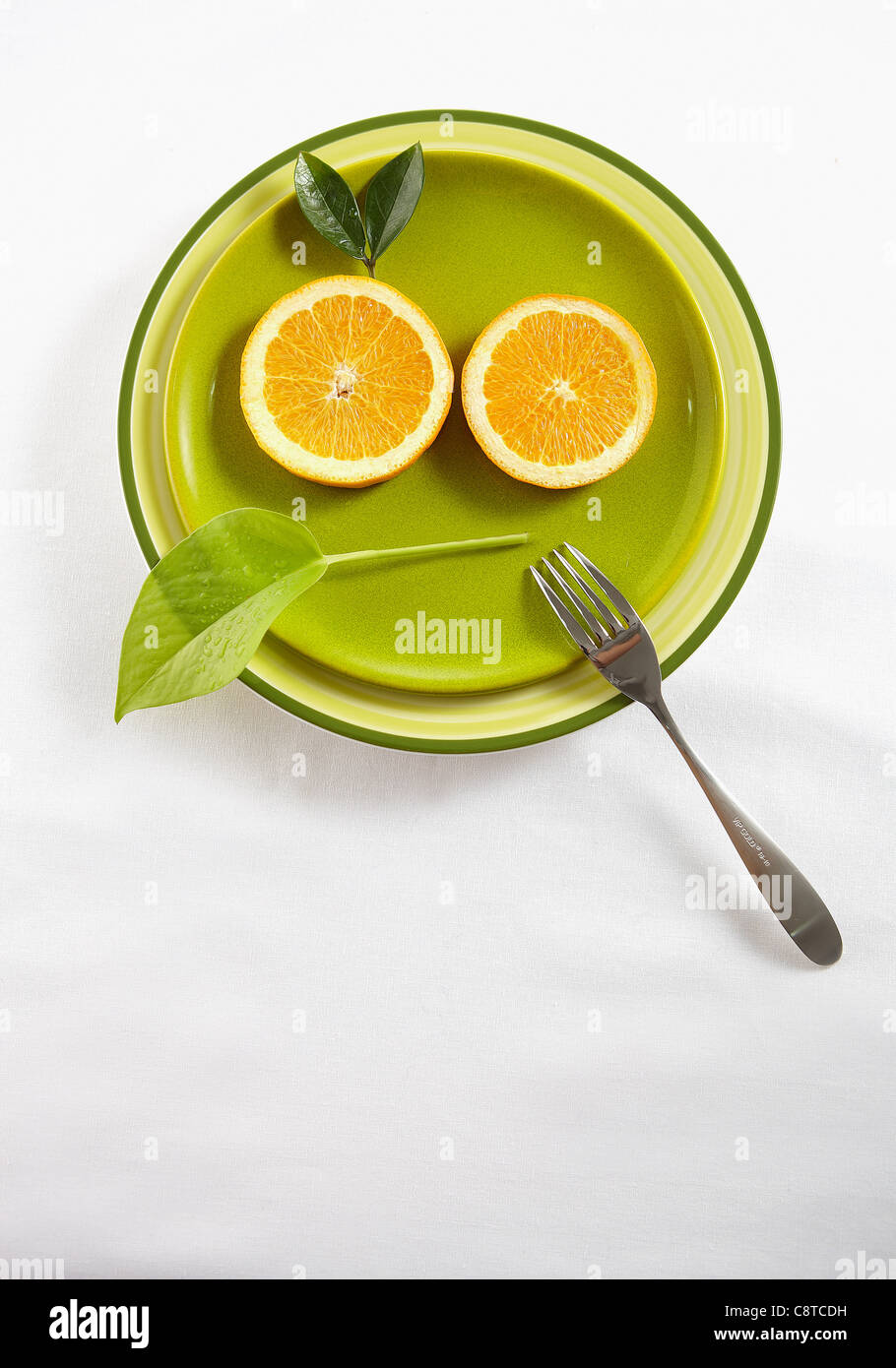 Slice Of Orange In A Plate Stock Photo - Alamy