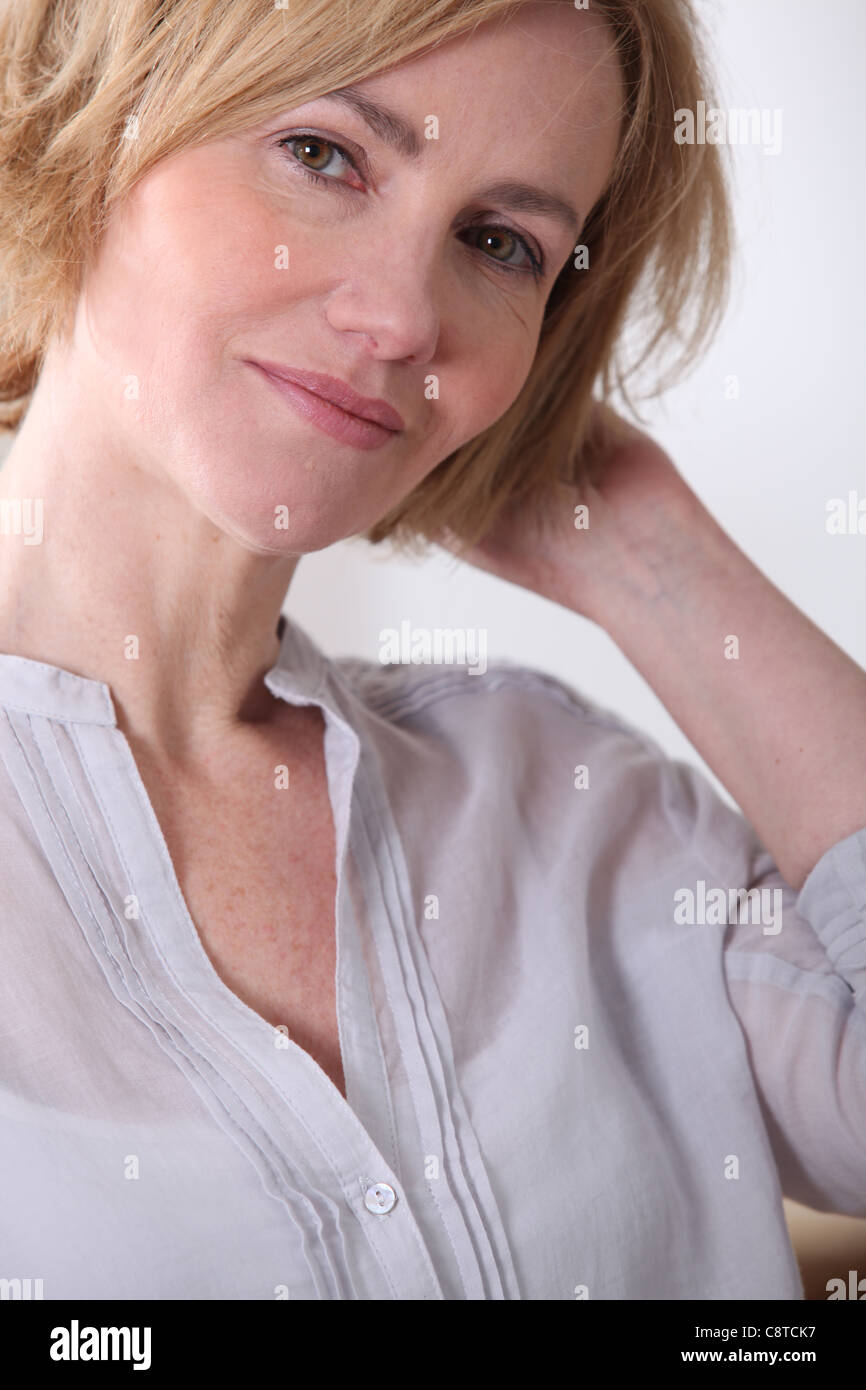 Woman with shy expression Stock Photo - Alamy