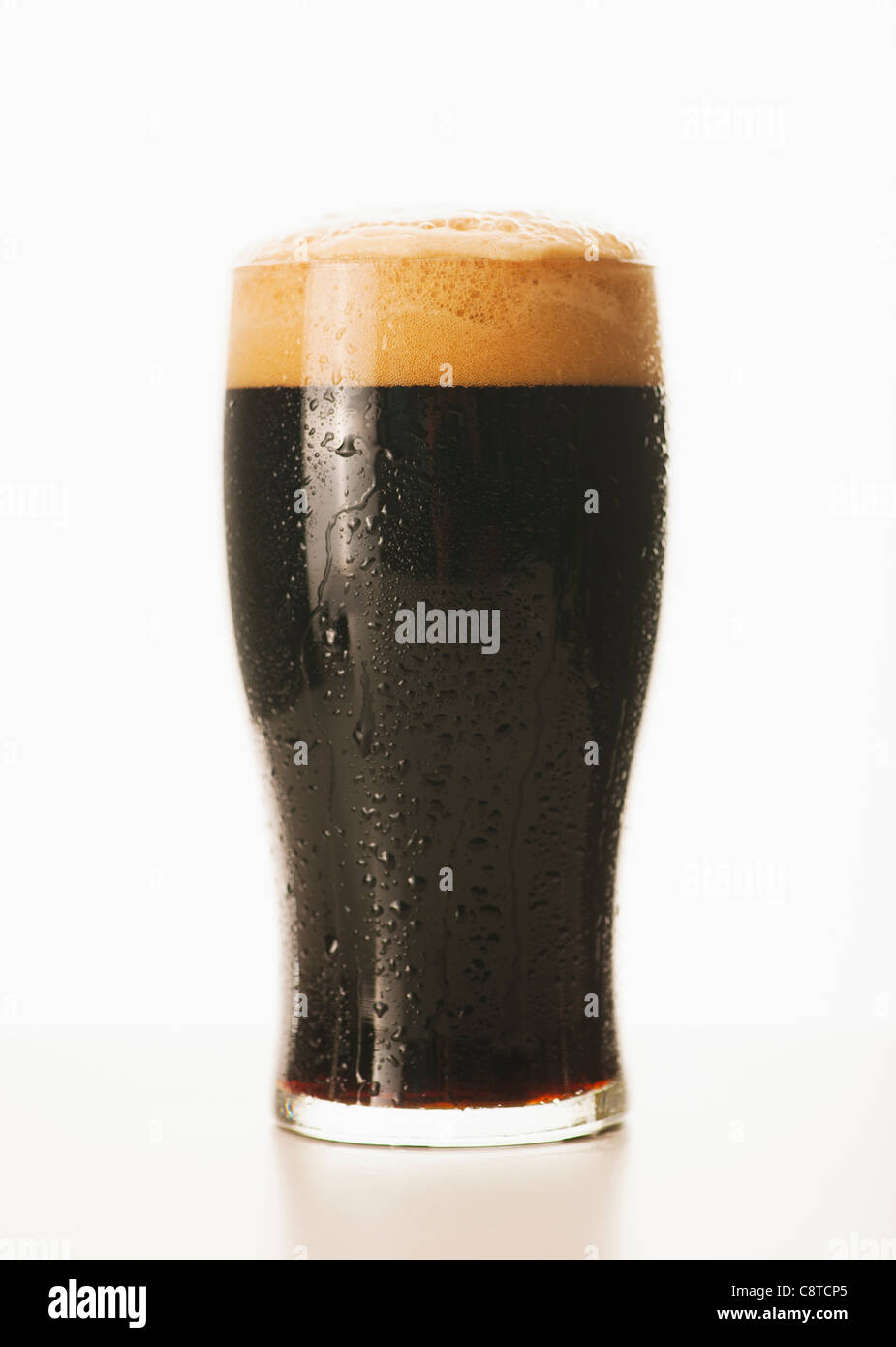 Studio shot of dark beer in glass Stock Photo - Alamy