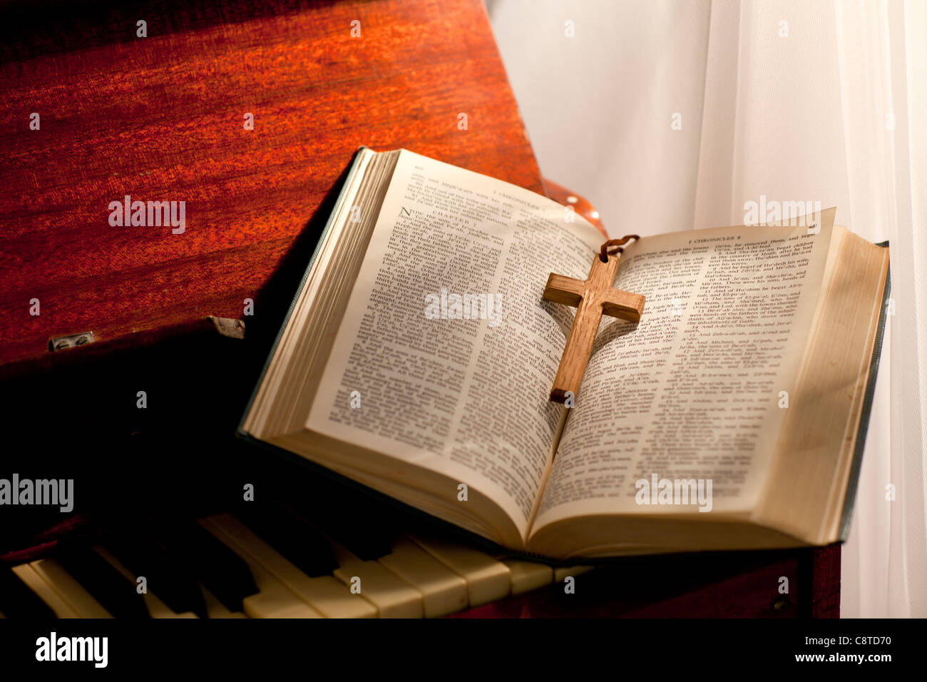 A wooden cross lying inside a bible Stock Photo - Alamy