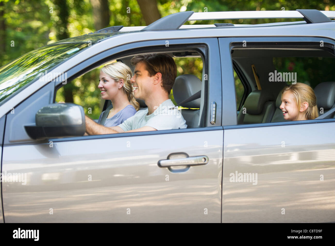 USA, New York State, Old Westbury, Parents with daughter driving car ...
