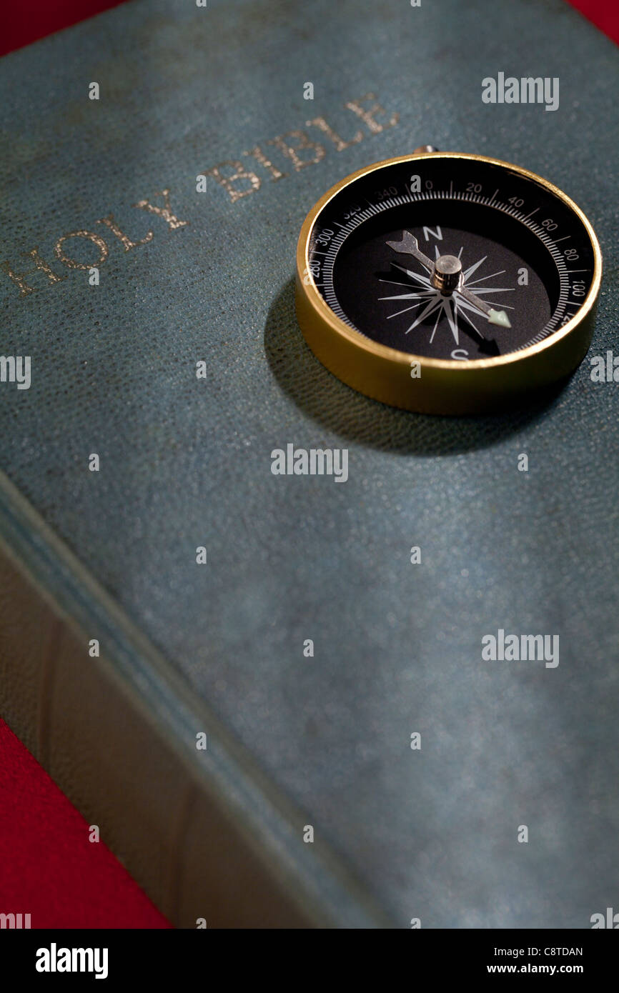 High angle view of Compass on Holy bible Stock Photo - Alamy
