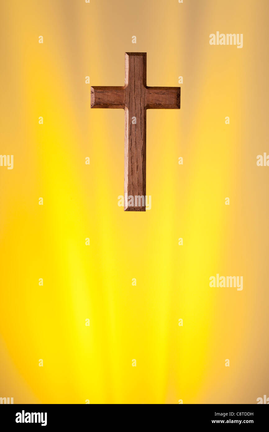 Cross over yellow background Stock Photo - Alamy