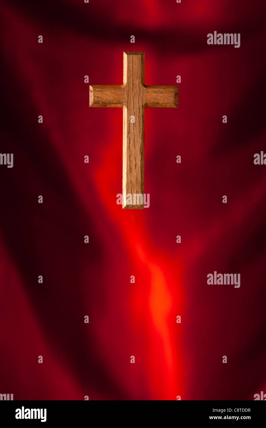Wooden cross over dark red background Stock Photo - Alamy