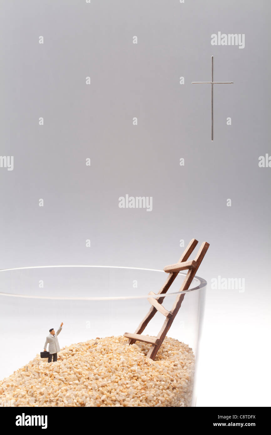 Man standing in sandstone pointing towards cross Stock Photo - Alamy