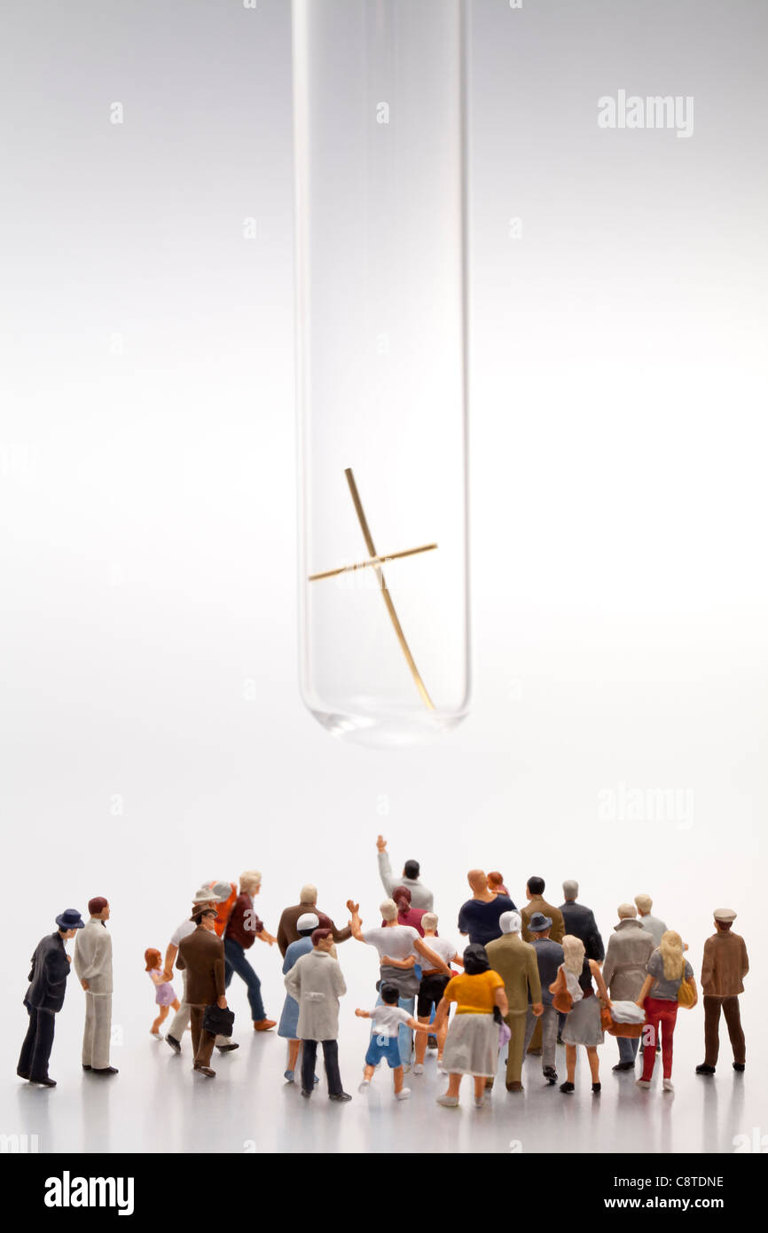 Cross in test tube with figurine on white background Stock Photo - Alamy