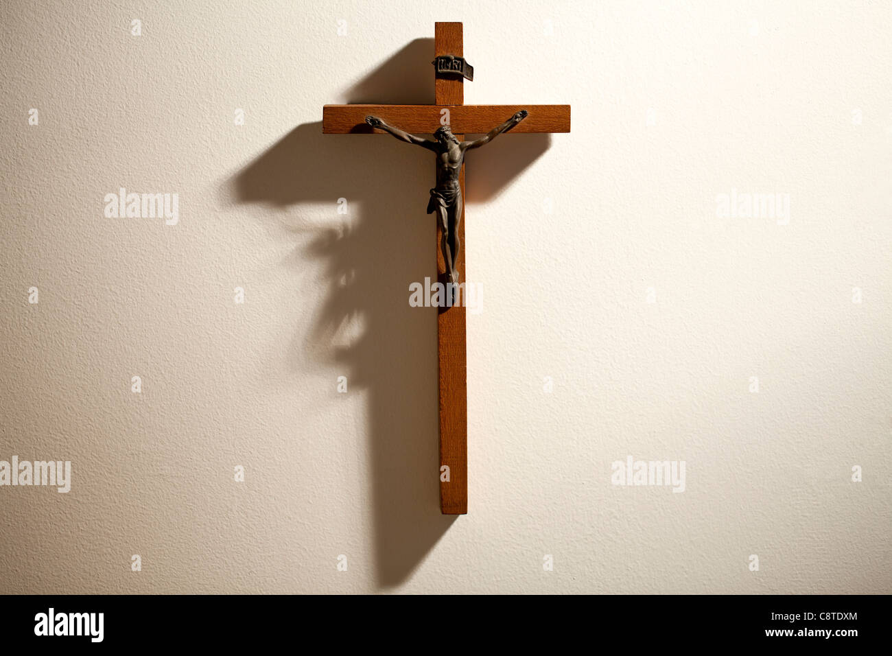 Wooden crucifix hanging on wall Stock Photo - Alamy