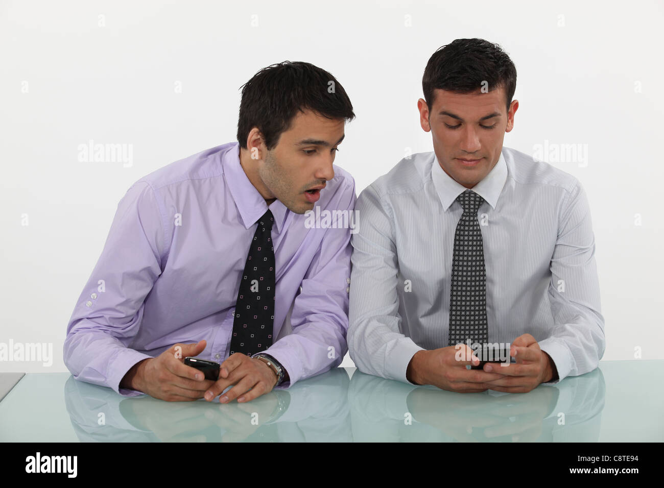 Two men with cellphones Stock Photo - Alamy