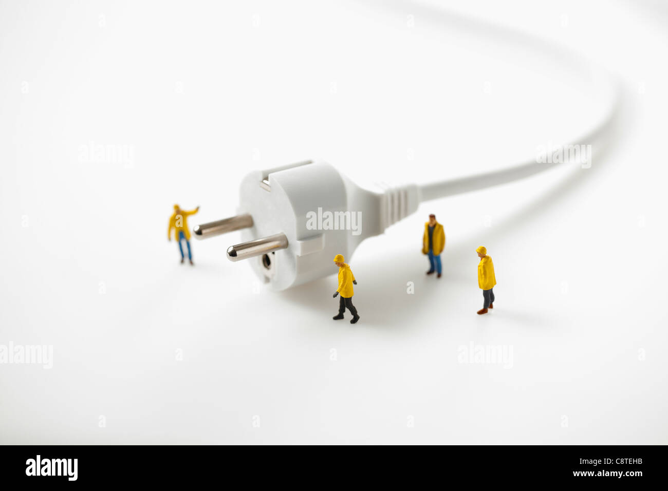 Close-up of electrical plug with small figurines Stock Photo - Alamy