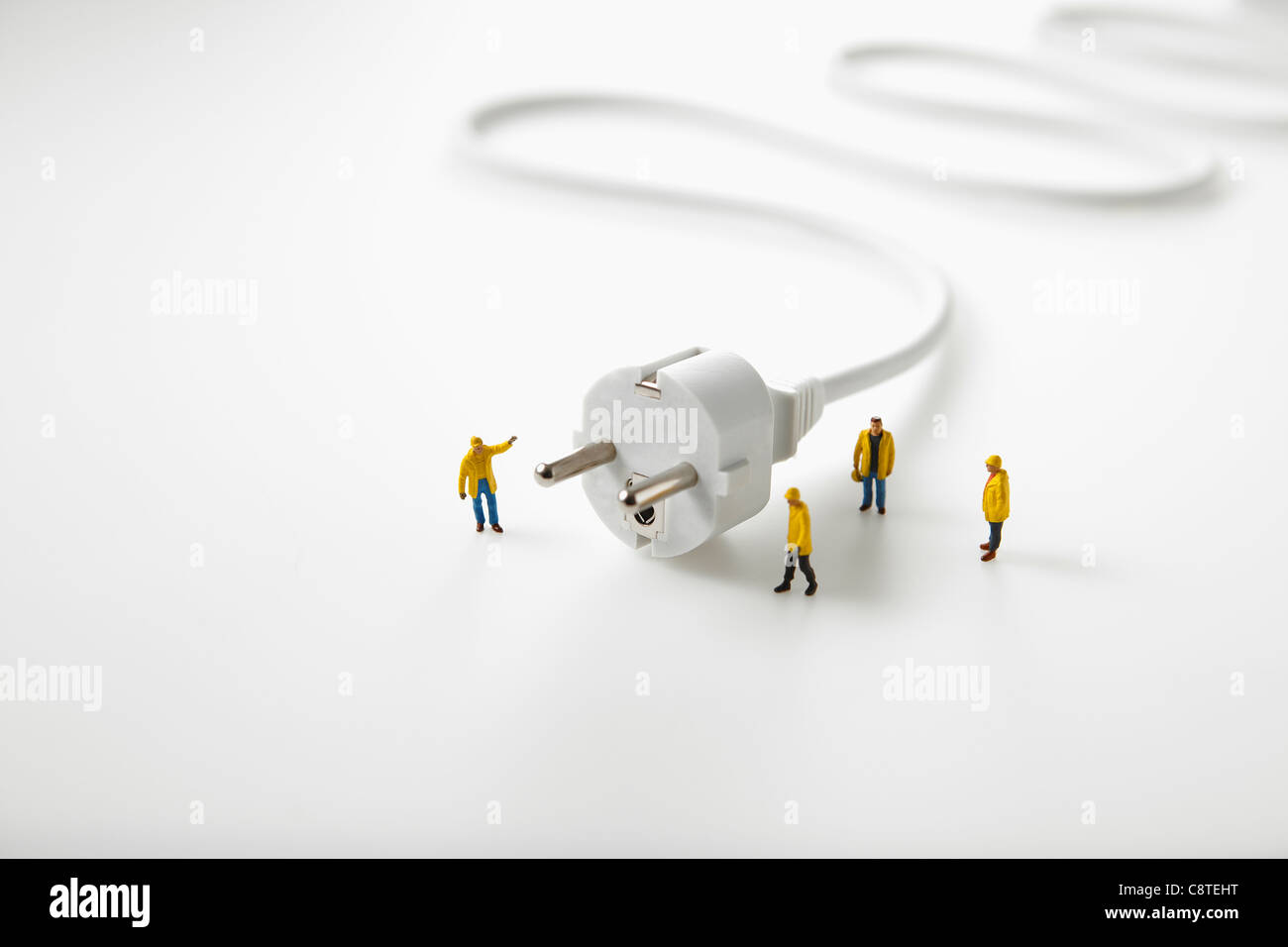 Close-up of electrical plug cable in zigzag with small figurine Stock ...