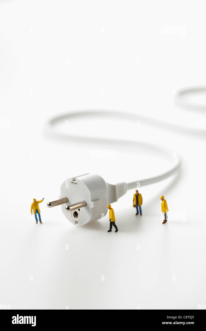 Close-up of electrical plug cable in zigzag with small figurine Stock ...