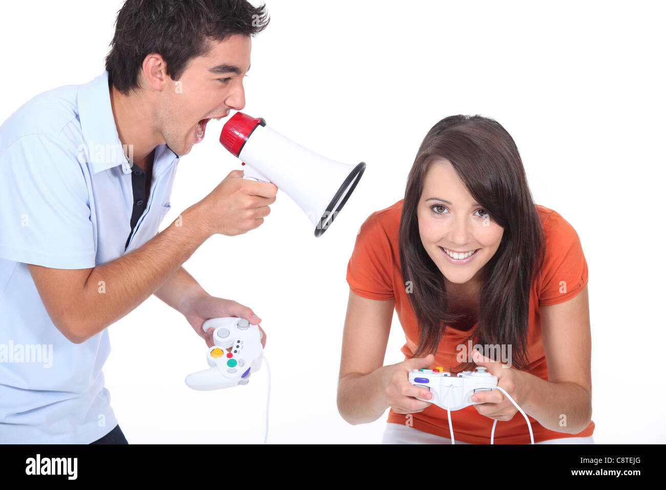 Man shouting into megaphone as girlfriend plays video game Stock Photo ...