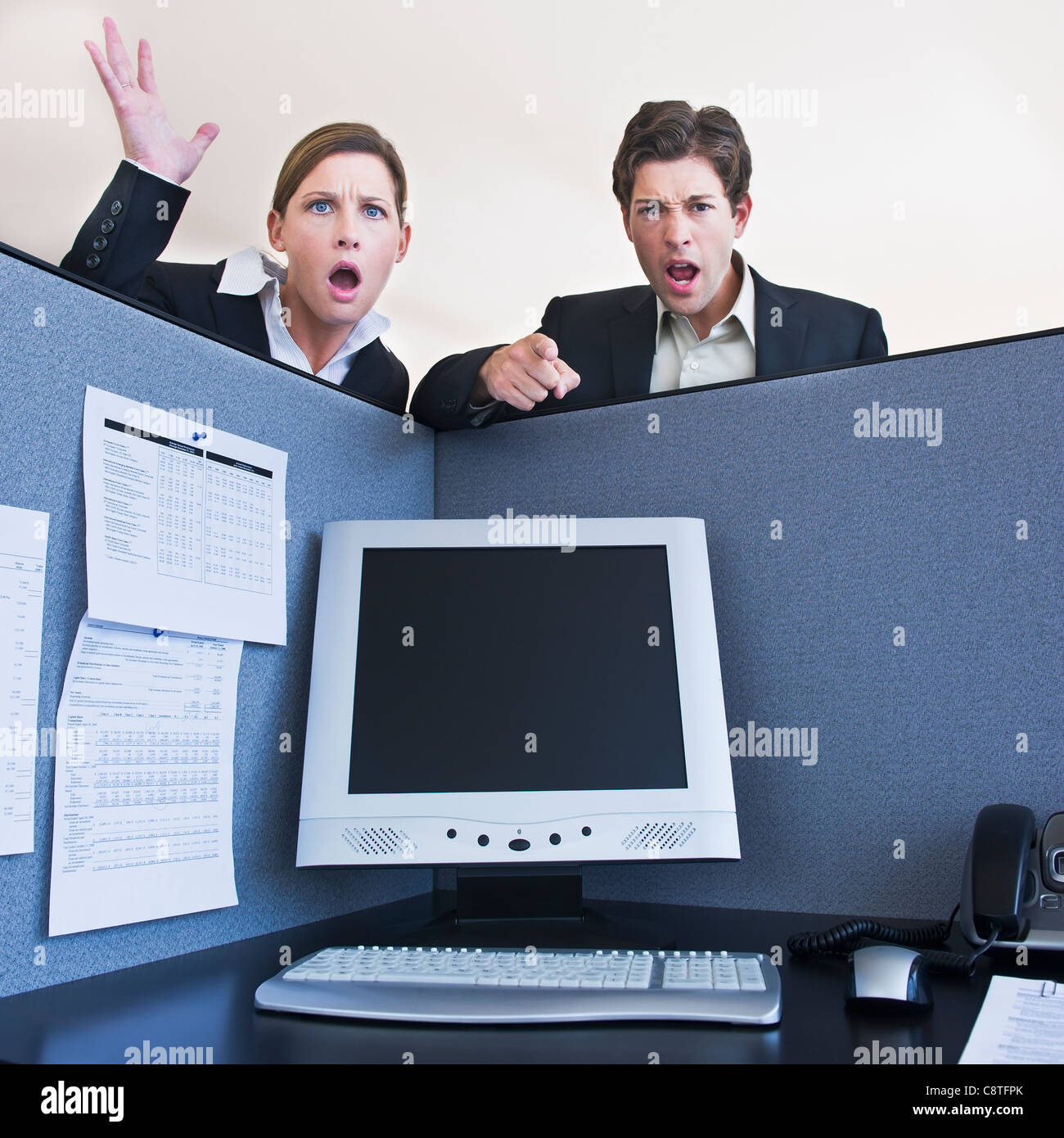 USA, New Jersey, Jersey City, Office workers shouting in office cubicle ...