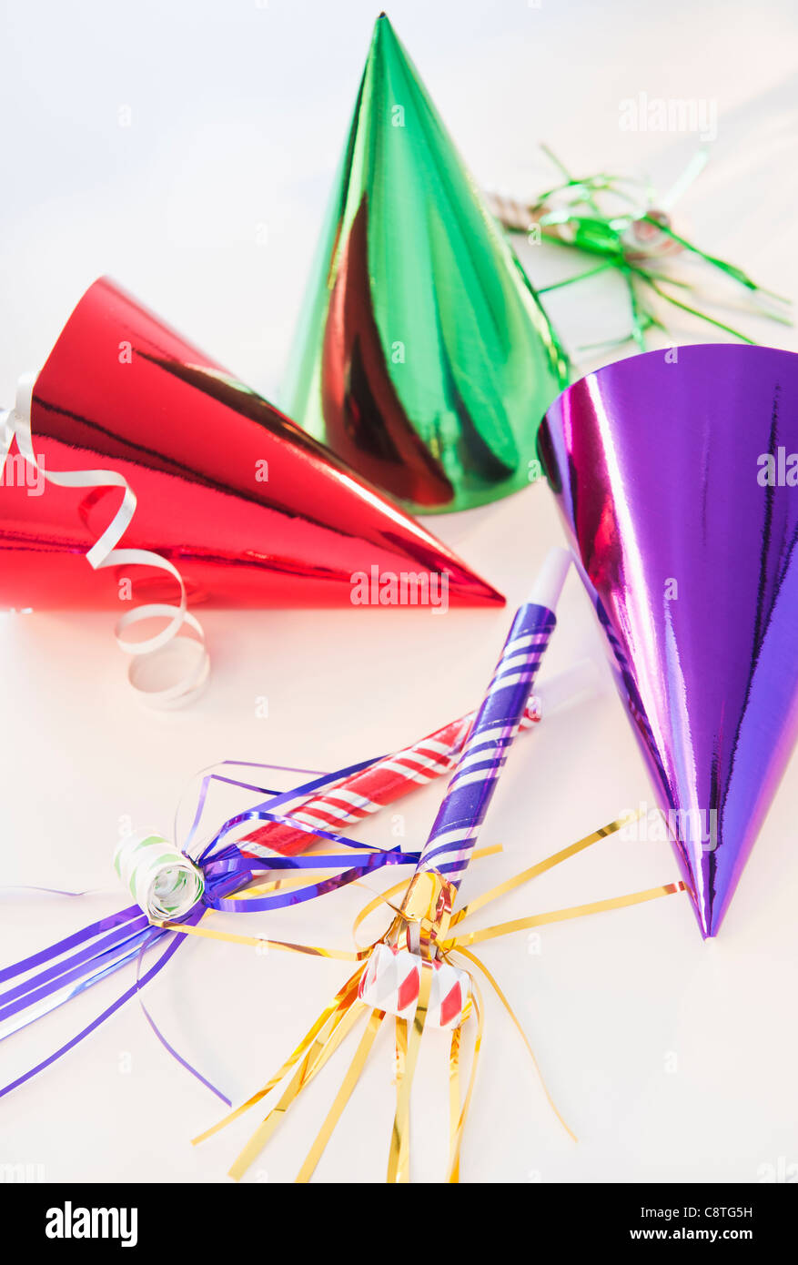 Party horn blowers and paper party hats Stock Photo - Alamy